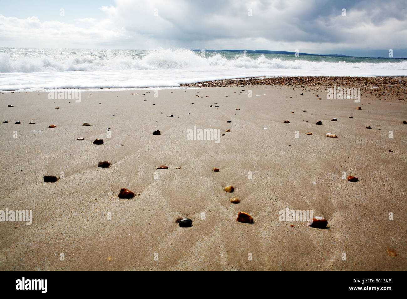 Pebbles on the sandy beach in Dorset England UK Stock Photo - Alamy
