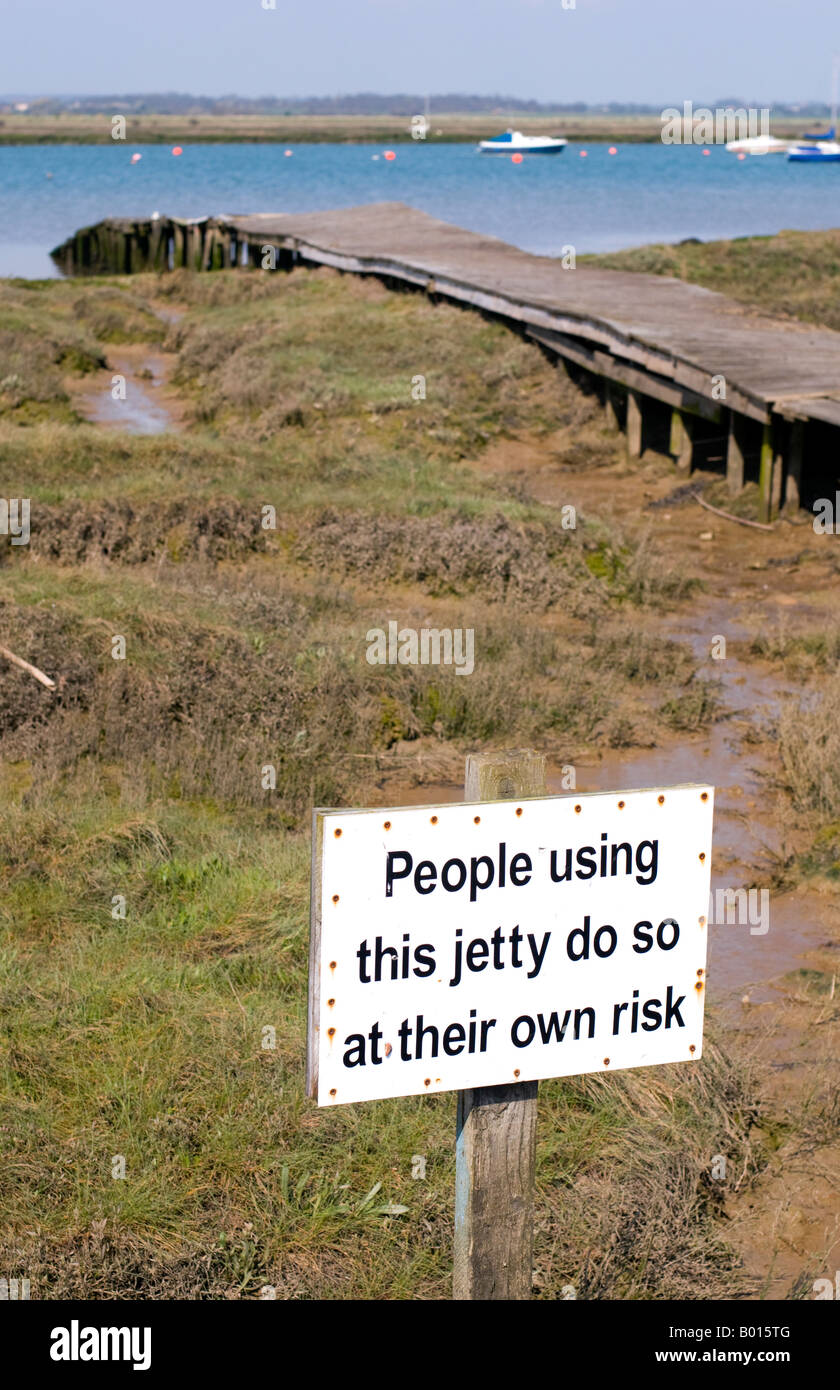 Sign giving warning about unstable jetty Stock Photo - Alamy