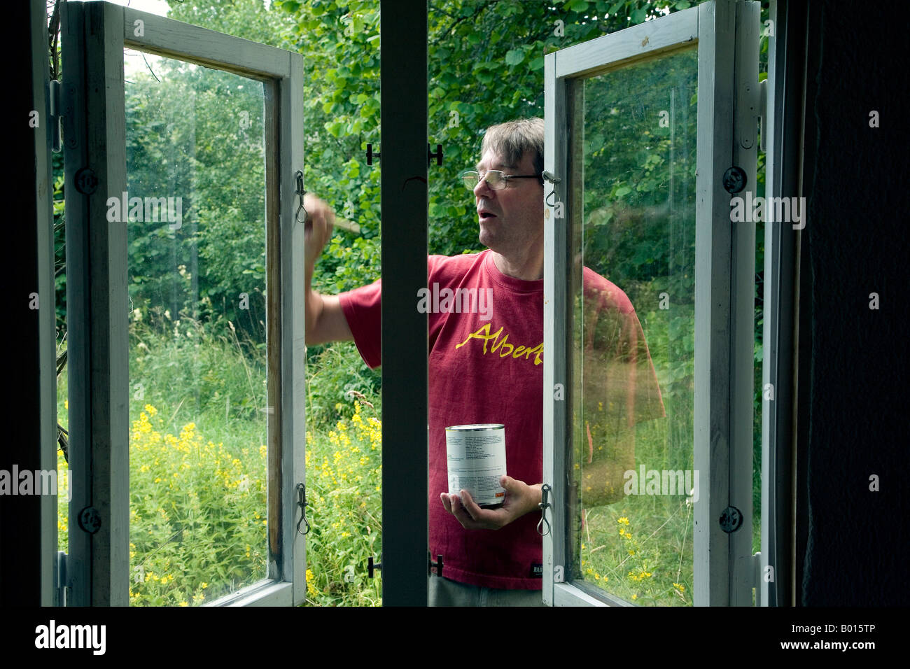 painter painting a window Stock Photo - Alamy