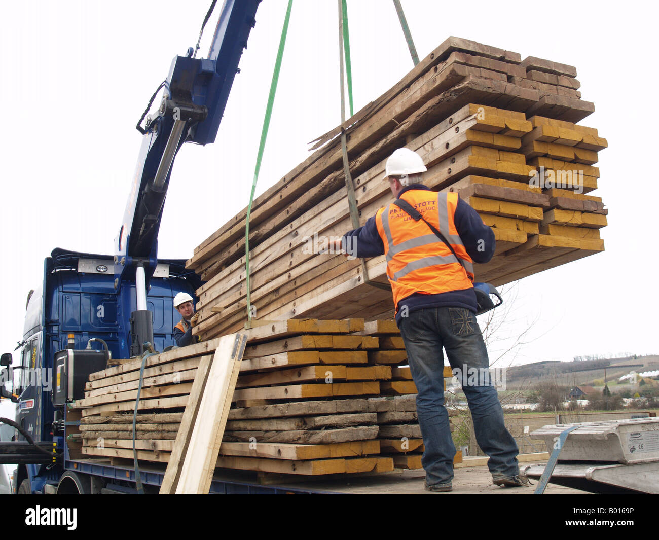 worker crane lifting large wooden decking platform Stock Photo - Alamy