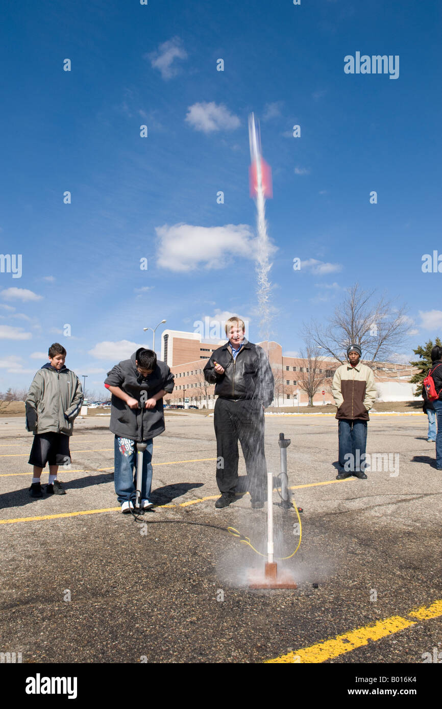 Teacher with students launching a water powered rocket Stock Photo - Alamy