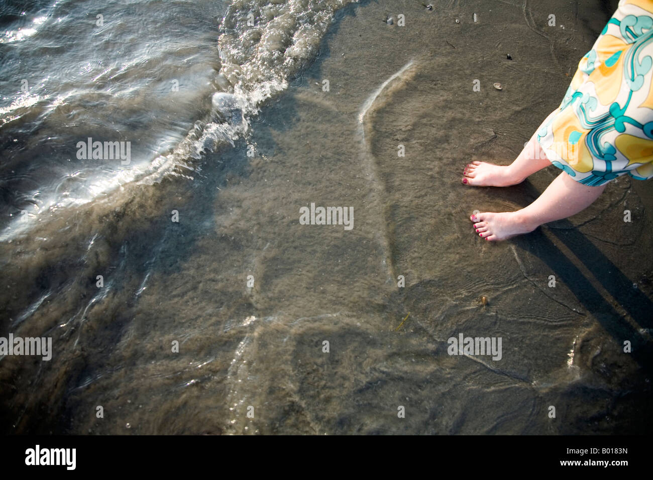 Soaking toes in the surf at the beach Stock Photo - Alamy