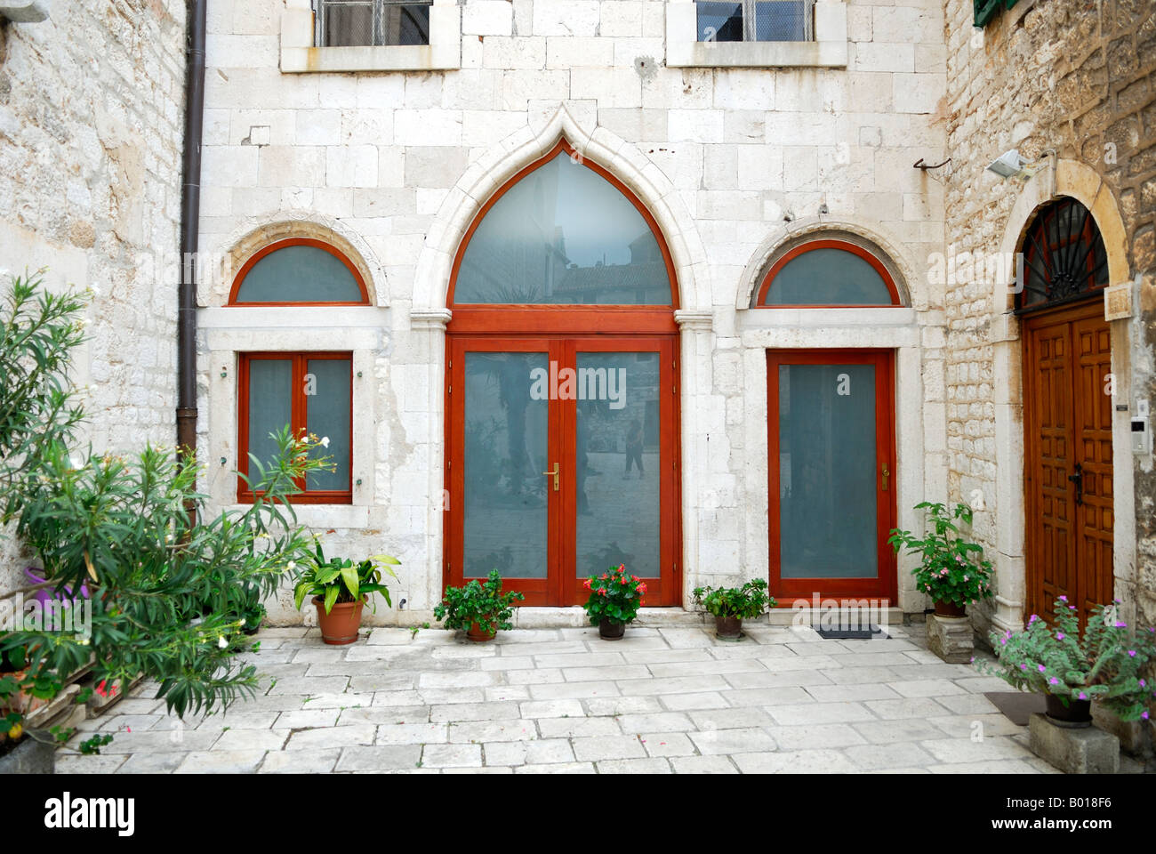 Courtyard with arched windows and Venetian Arch doorway Sibenik Croatia ...