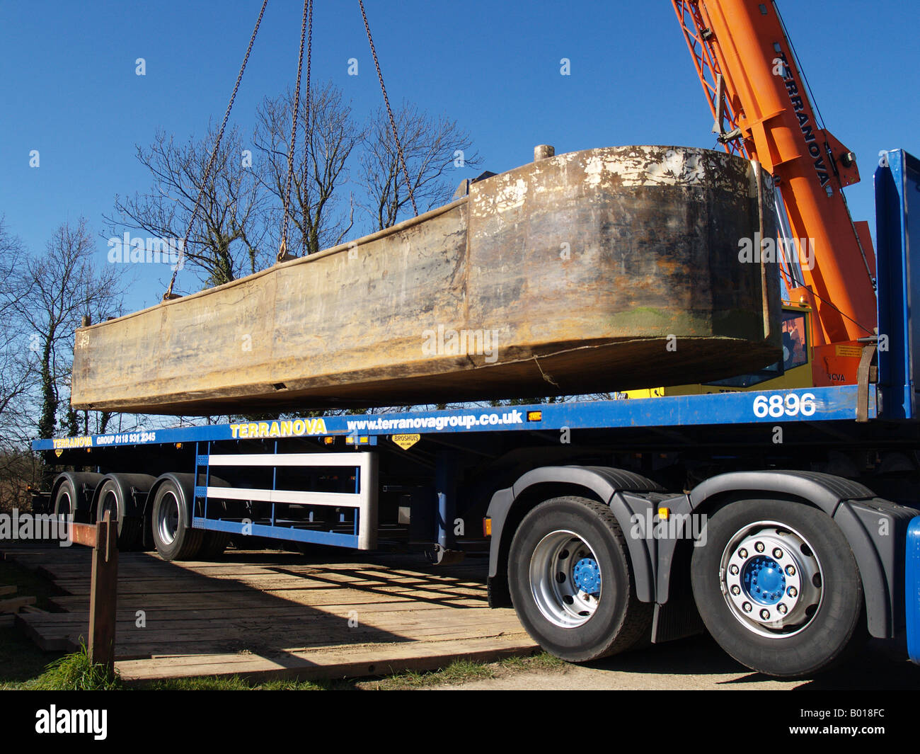lorry crane raising river dredger waste hopper Stock Photo - Alamy