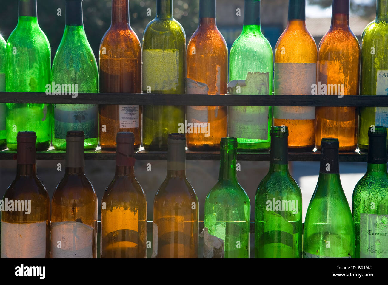 Empty wine bottle rack with glass bottles of various colours Stock ...