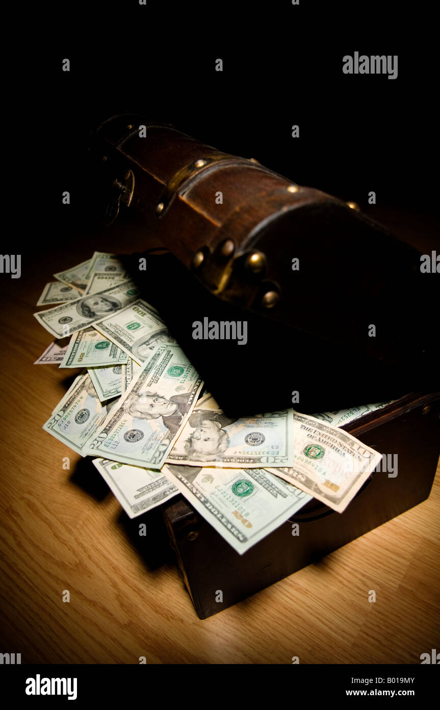 Treasure chest full of money Stock Photo - Alamy