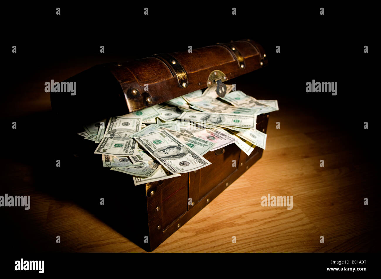 Treasure chest full of money Stock Photo - Alamy