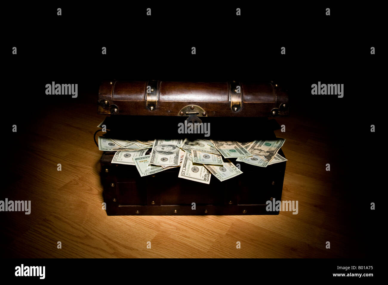 Treasure chest full of money Stock Photo - Alamy