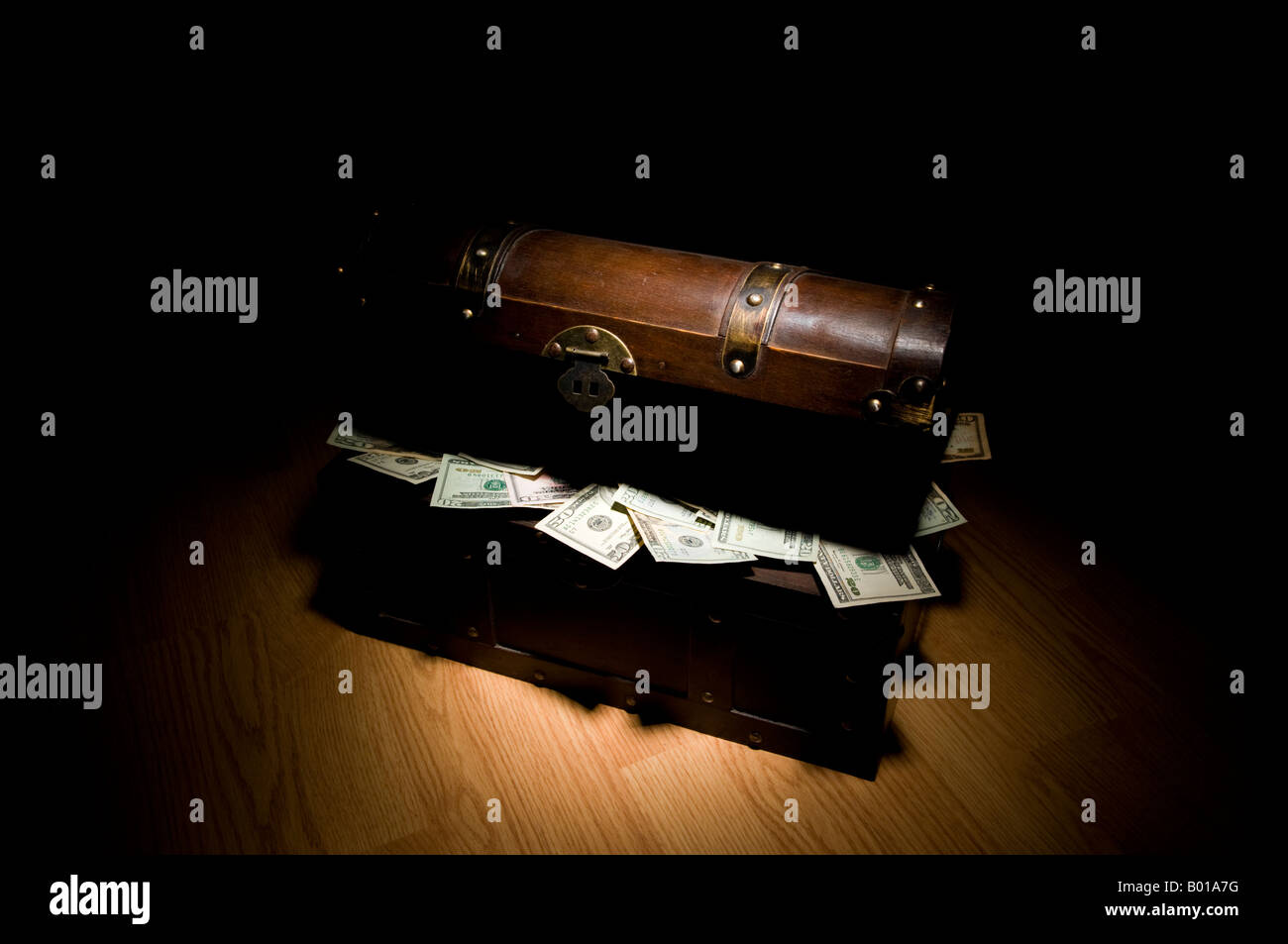Treasure chest full of money Stock Photo - Alamy