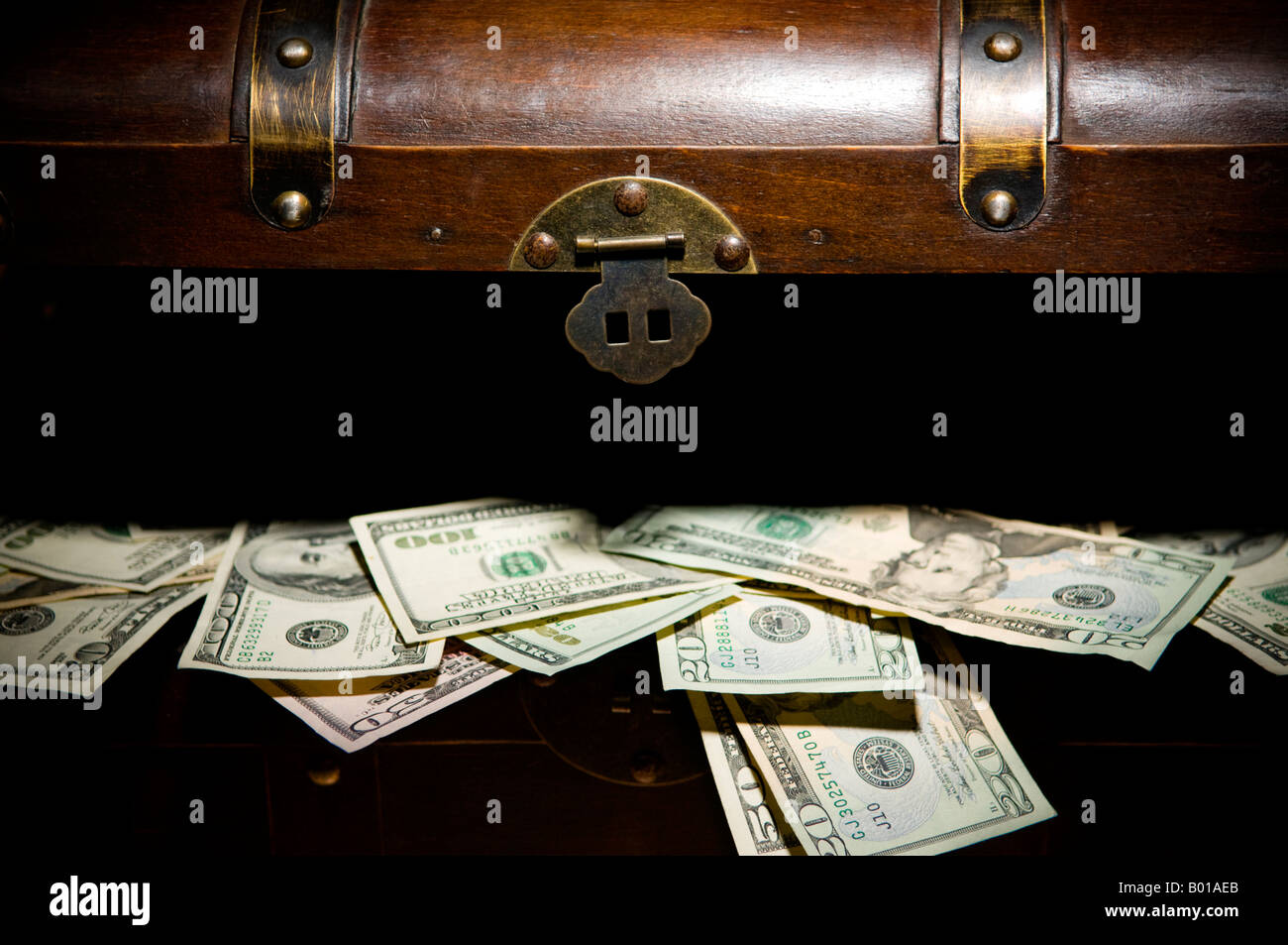 Treasure chest full of money Stock Photo - Alamy