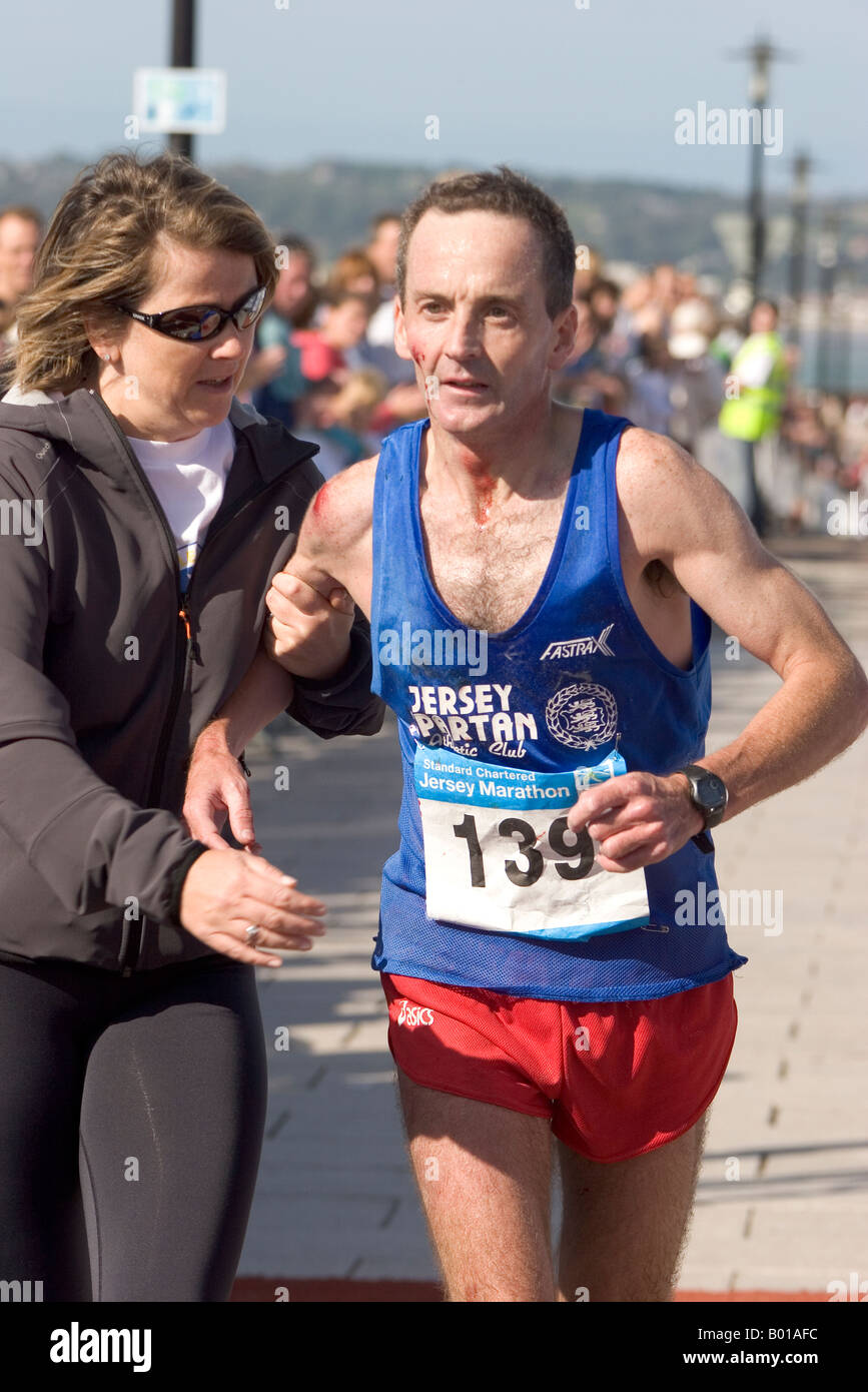 exhausted marathon runner injured having fell over nearing finishing ...