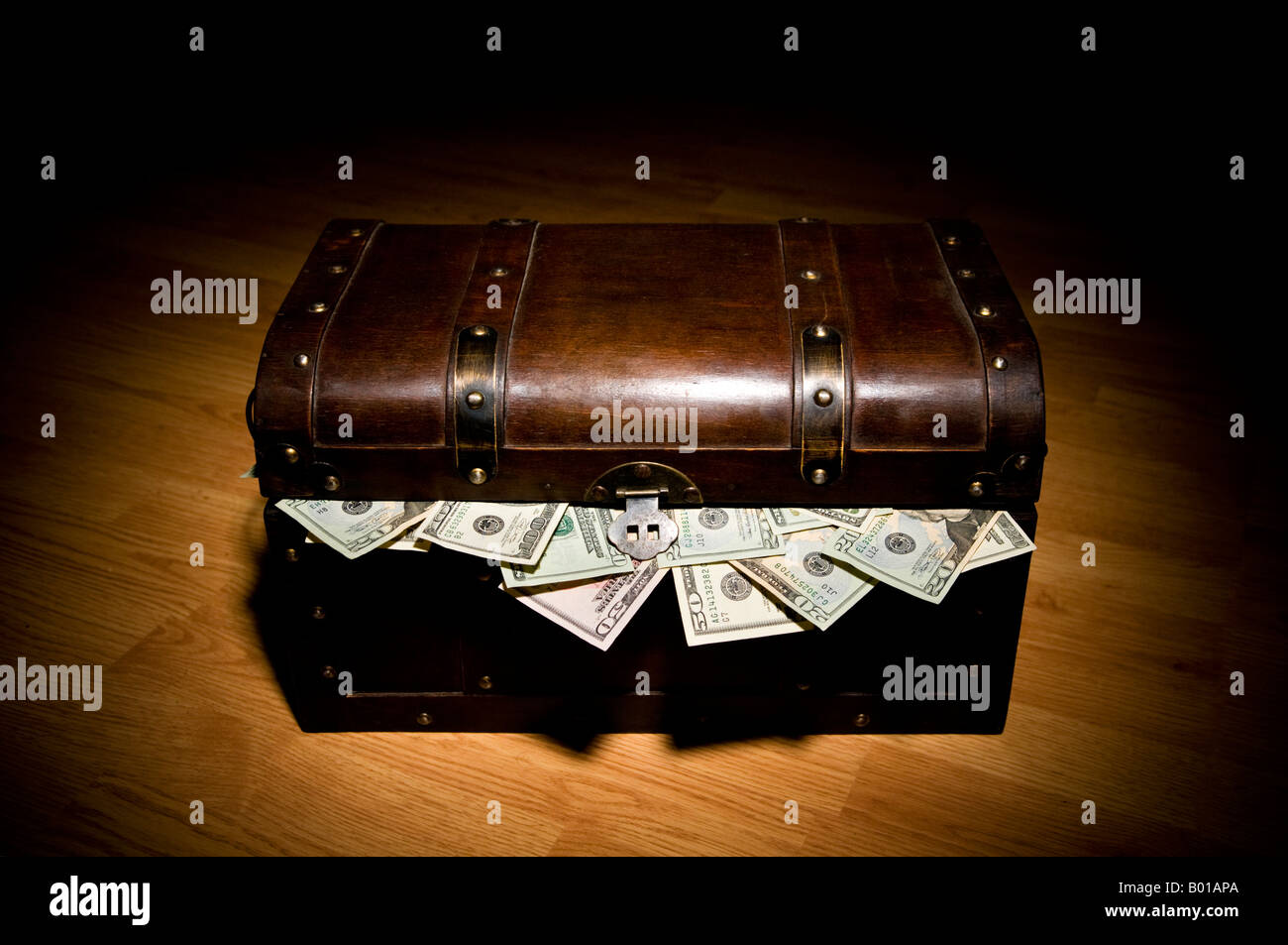 Treasure chest full of money Stock Photo - Alamy