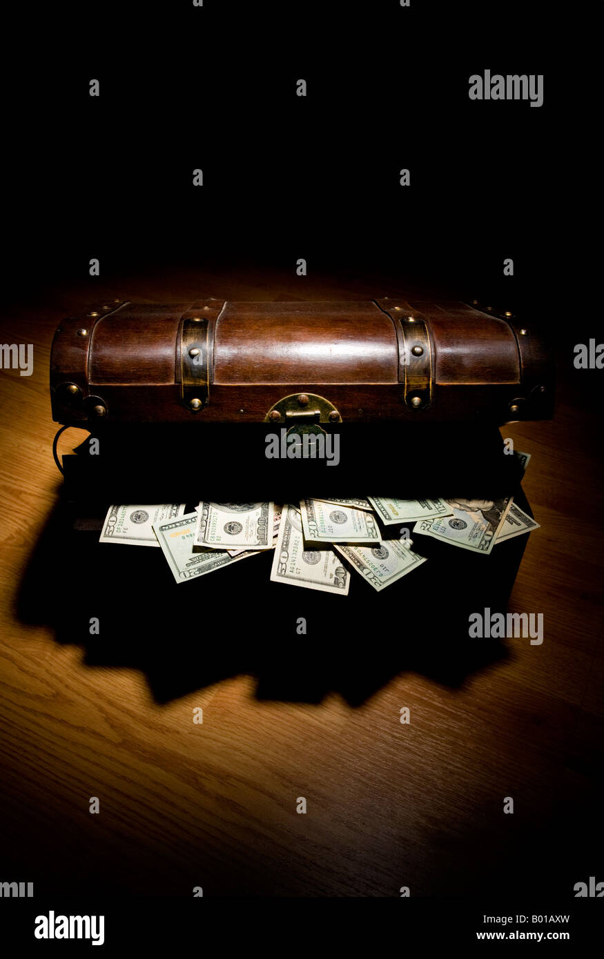 Treasure chest full of money Stock Photo - Alamy