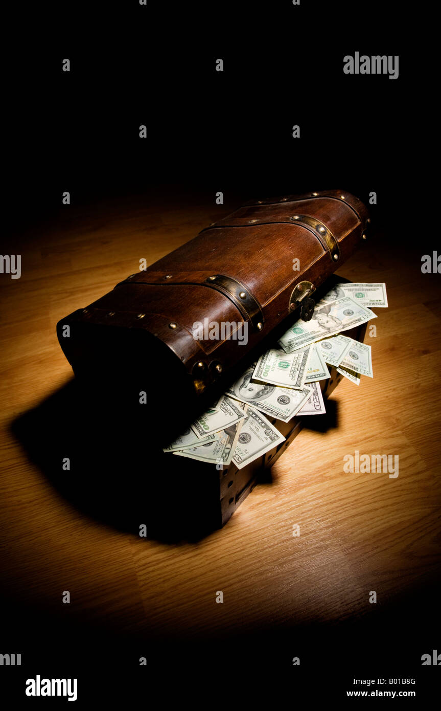 Treasure chest full of money Stock Photo - Alamy