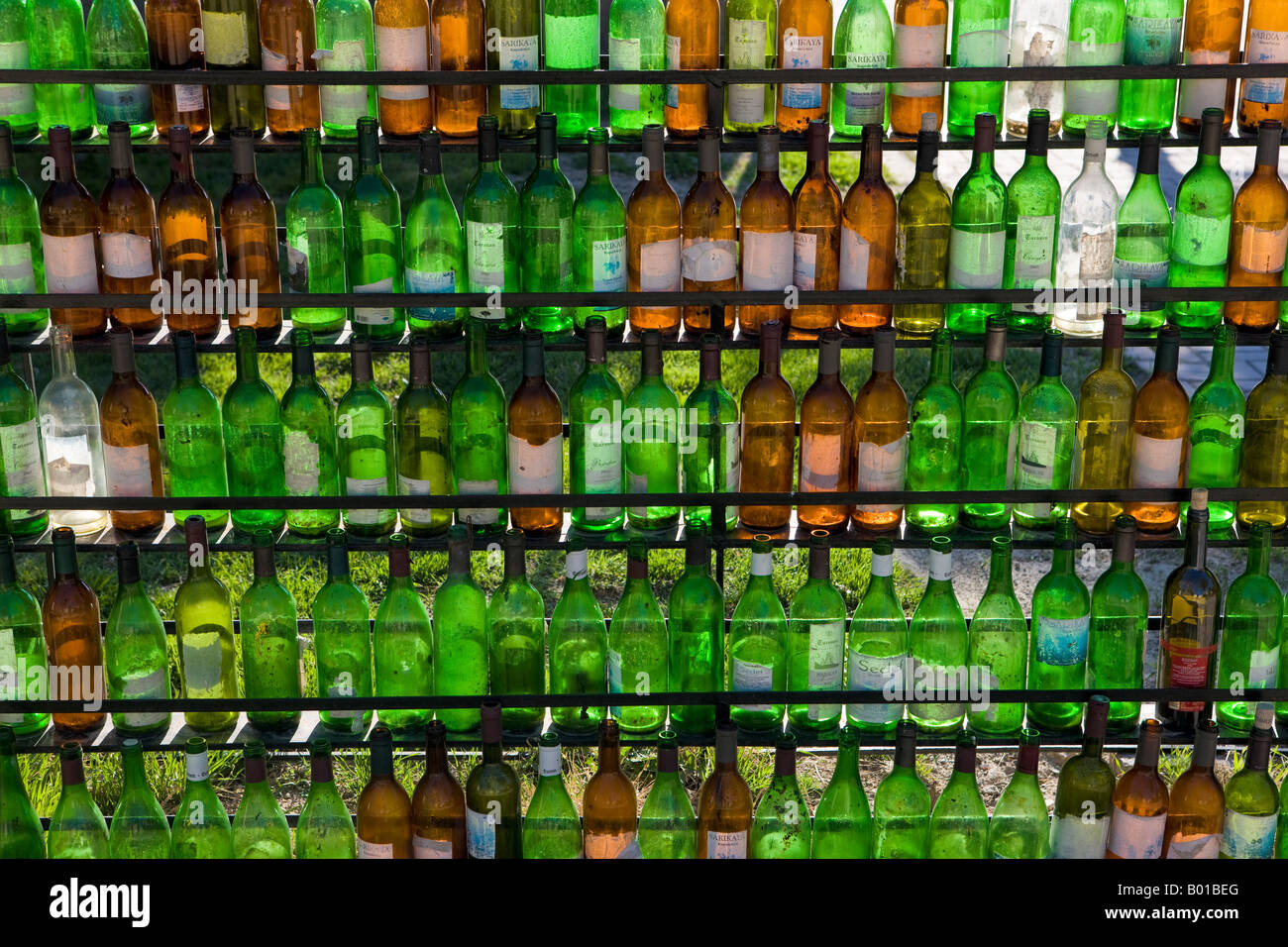 Empty wine bottle rack with glass bottles of various colours Stock ...