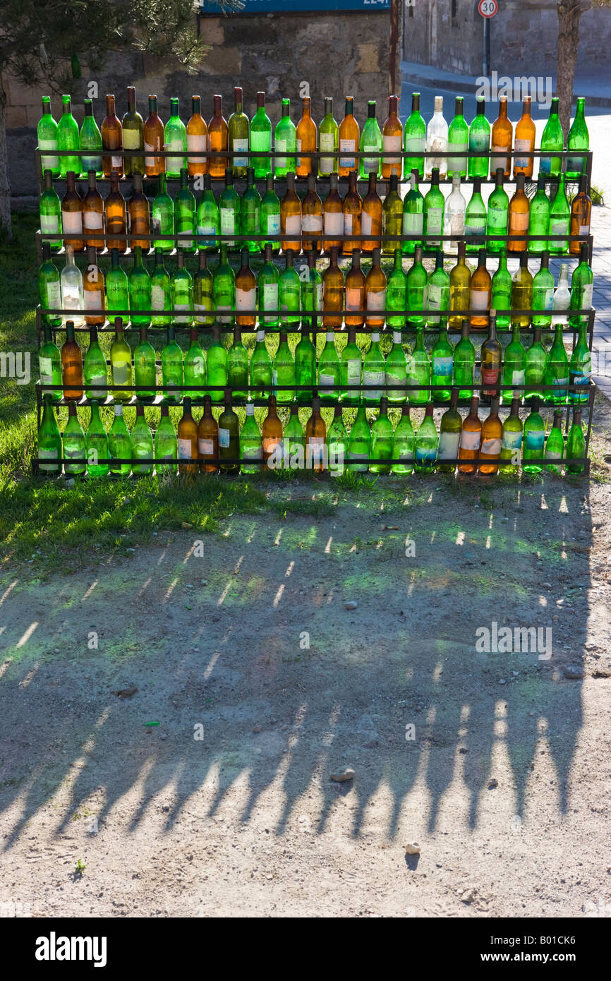 Empty wine bottle rack with glass bottles of various colours Stock ...