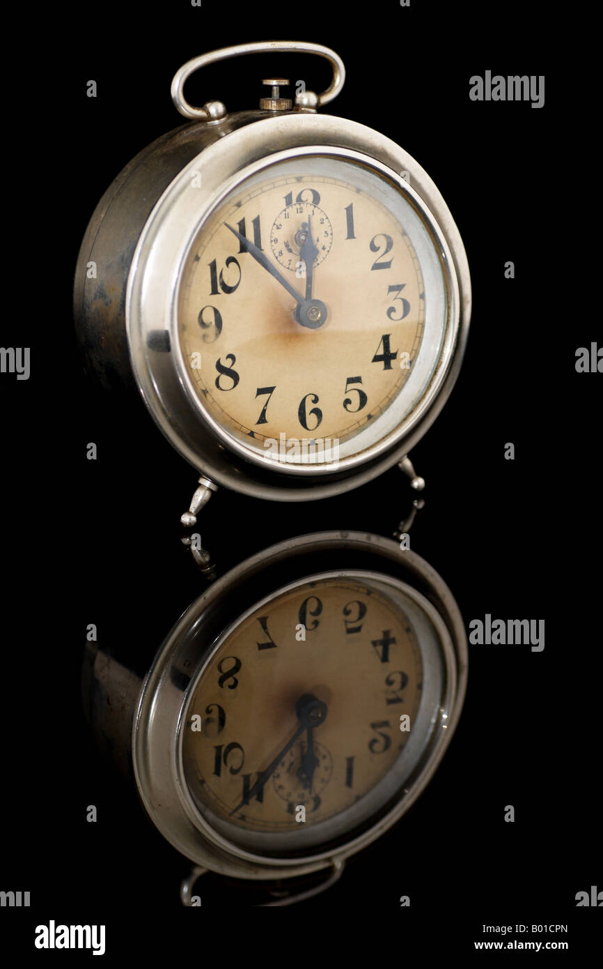 old clock on black background Stock Photo - Alamy