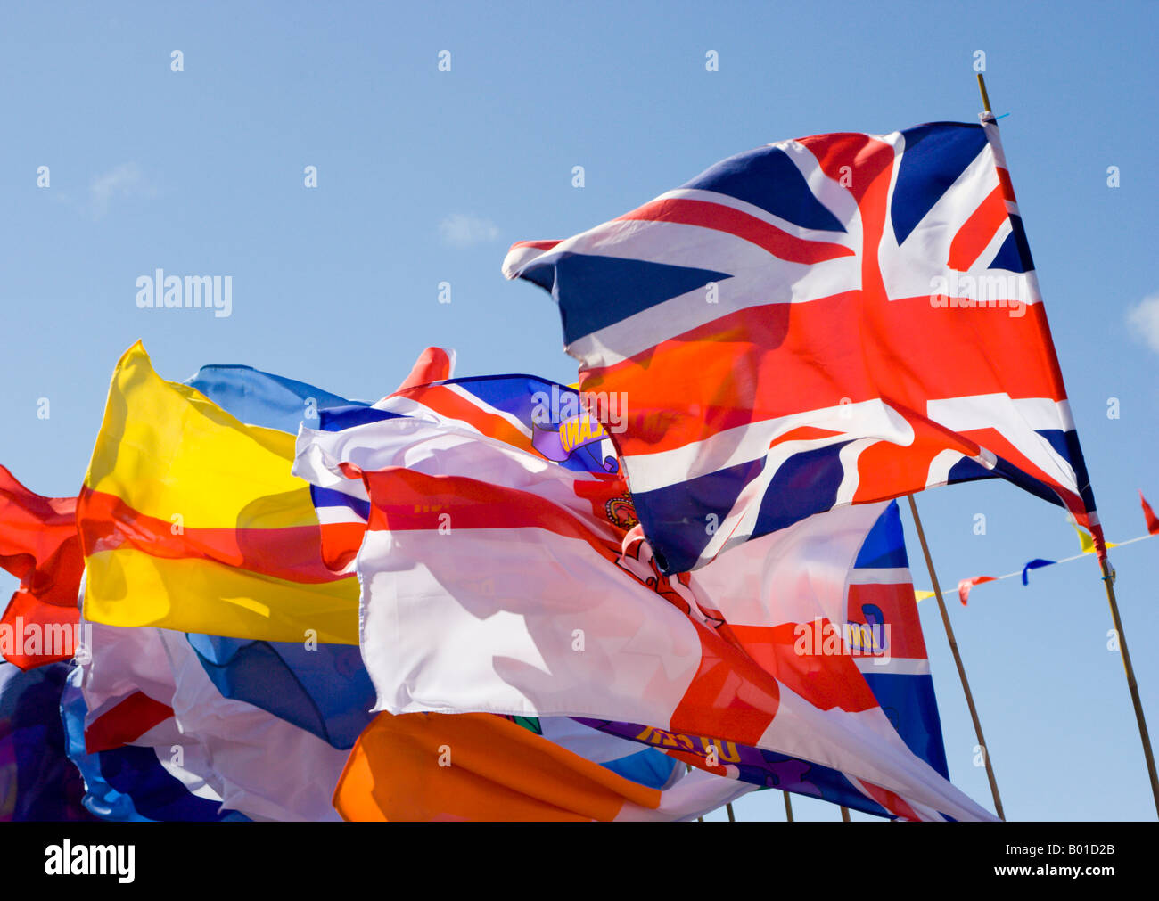Flags on a windy day against a blue sky Stock Photo - Alamy