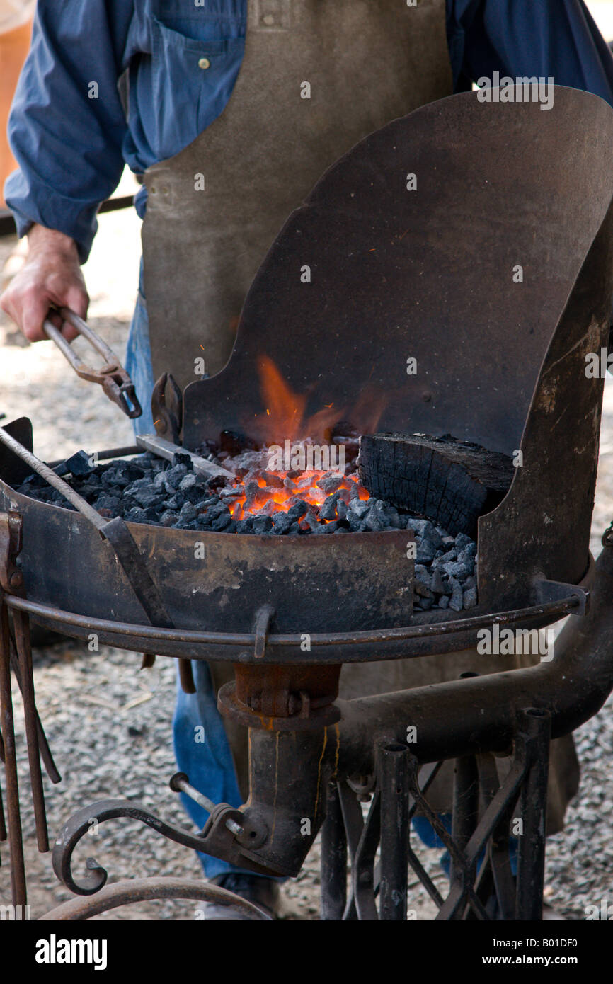 A blacksmith working over a fire Stock Photo - Alamy
