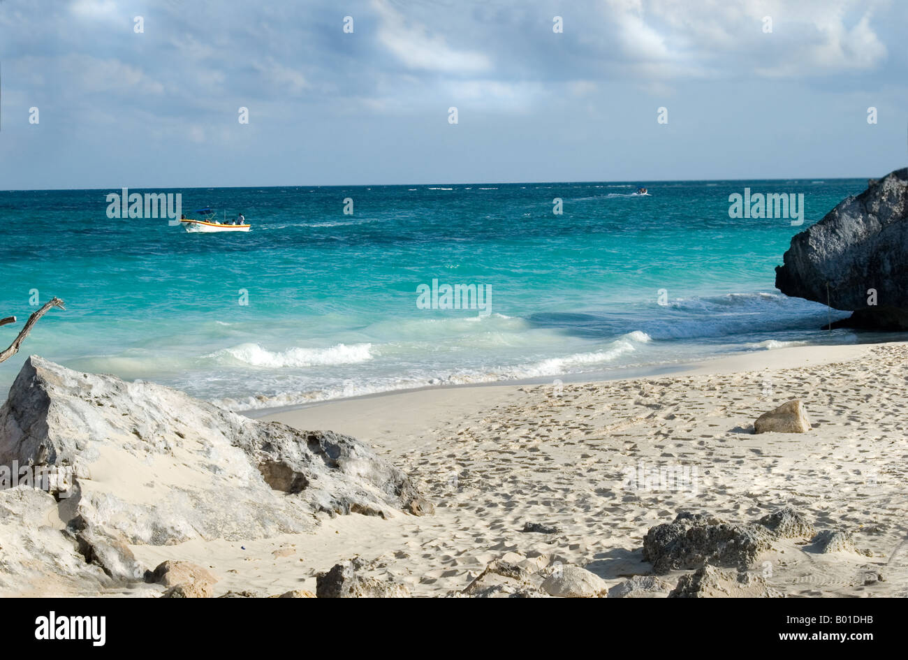 tropical beach with a fishing boat in the sea Stock Photo - Alamy