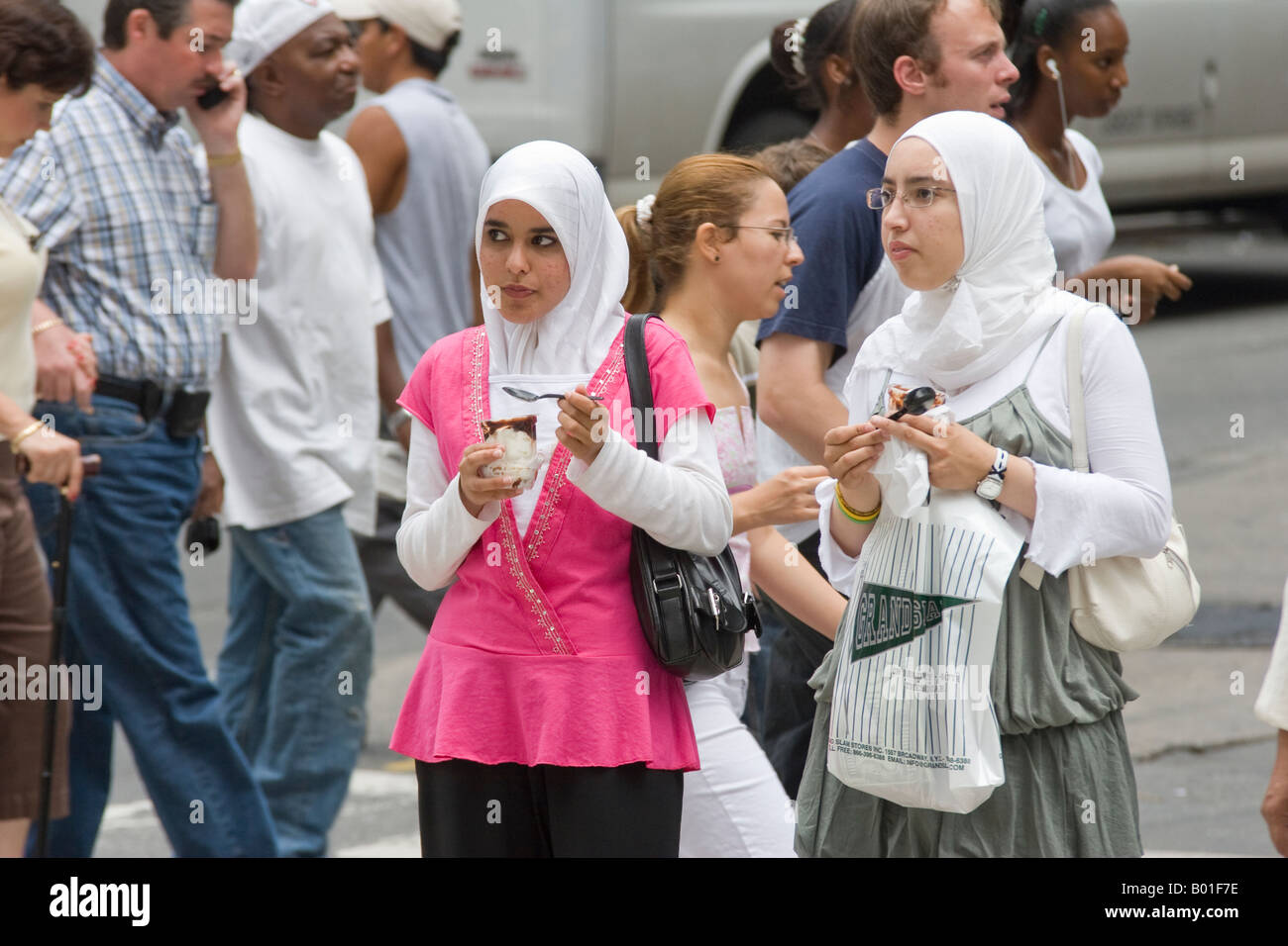 Two girls wearing traditional Muslim scarves in Times Square, New York ...
