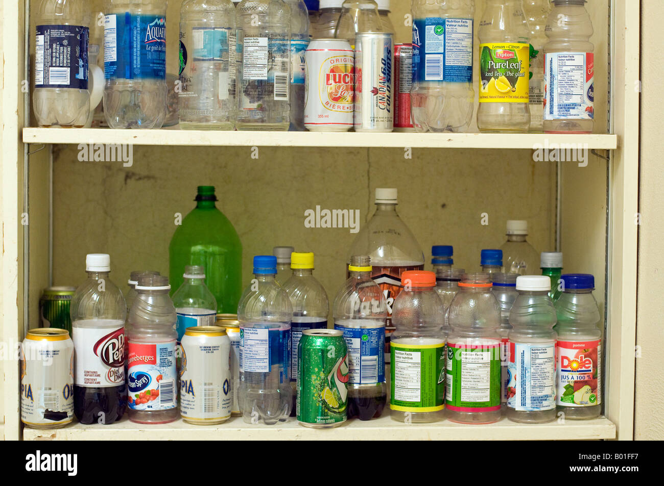 A range of empty plastic bottles and cans on a shelf Stock Photo - Alamy
