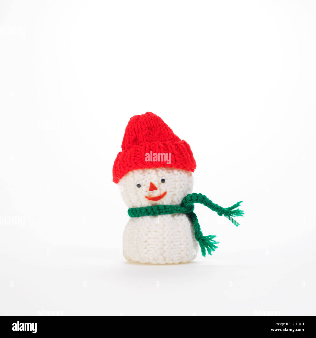 knit snowman with red cap and green scarf Stock Photo - Alamy