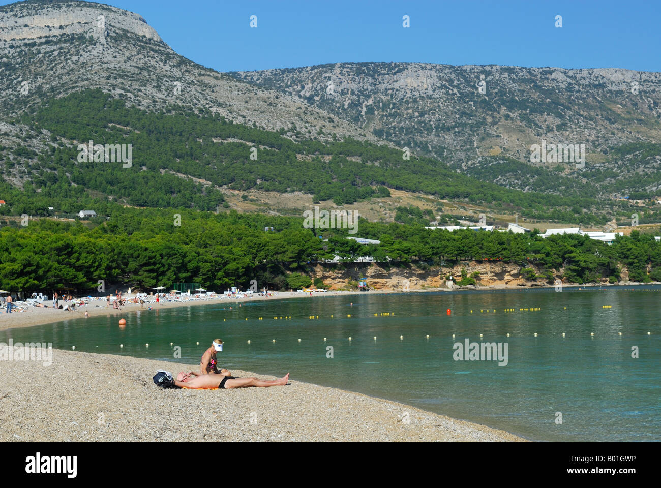 Sunbakers on beach at Zlatni Rat near Bol island of Brac Croatia Stock ...