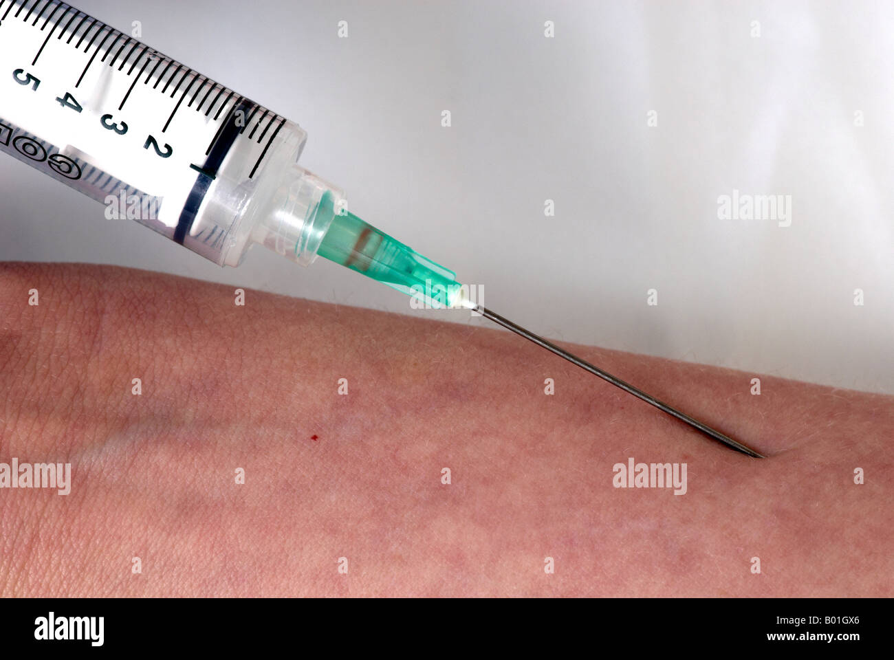 Simulating the use of a needle in the arm Stock Photo - Alamy