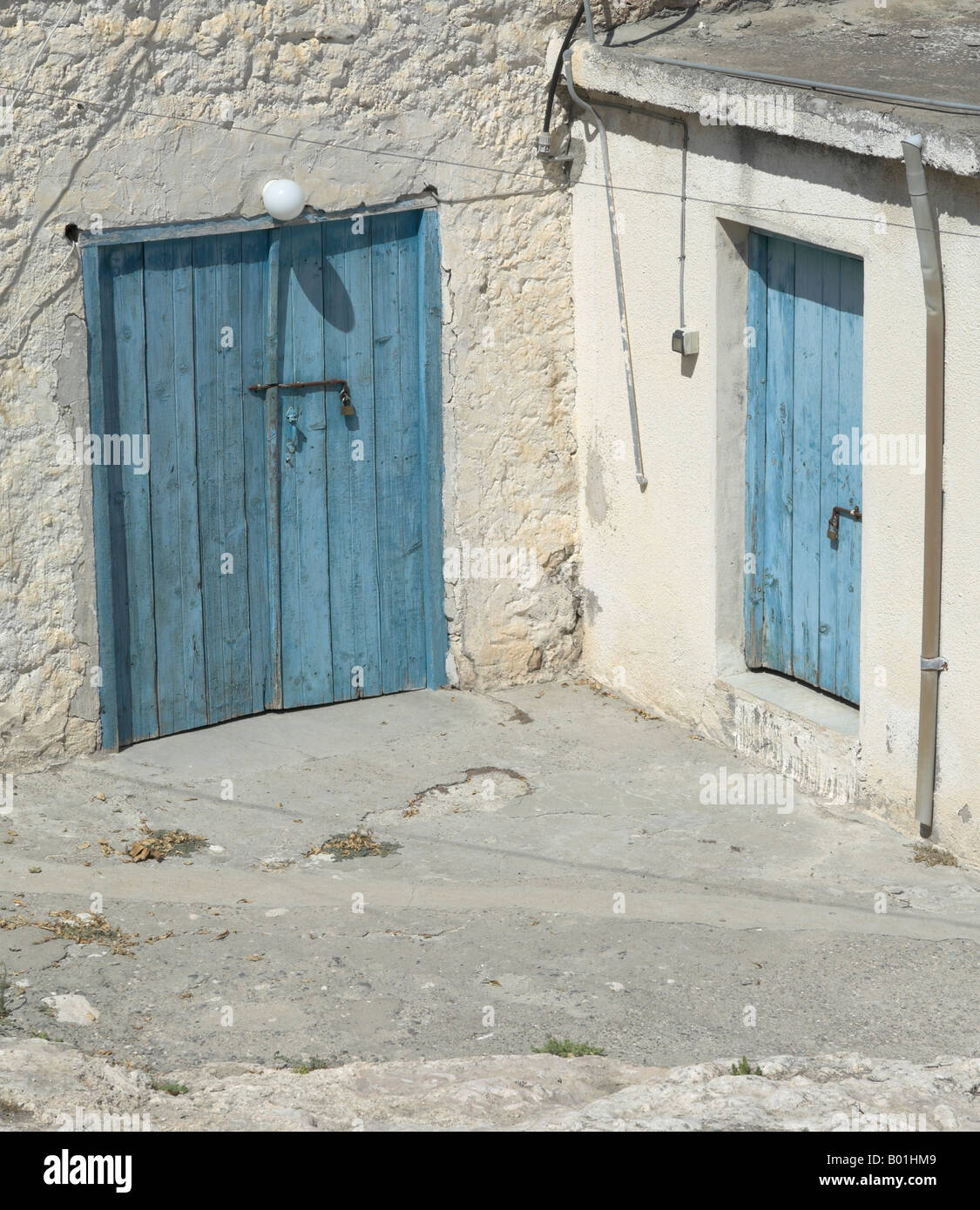 Two blue doors in a quiet courtyard in the traditional Greek Cypriot ...