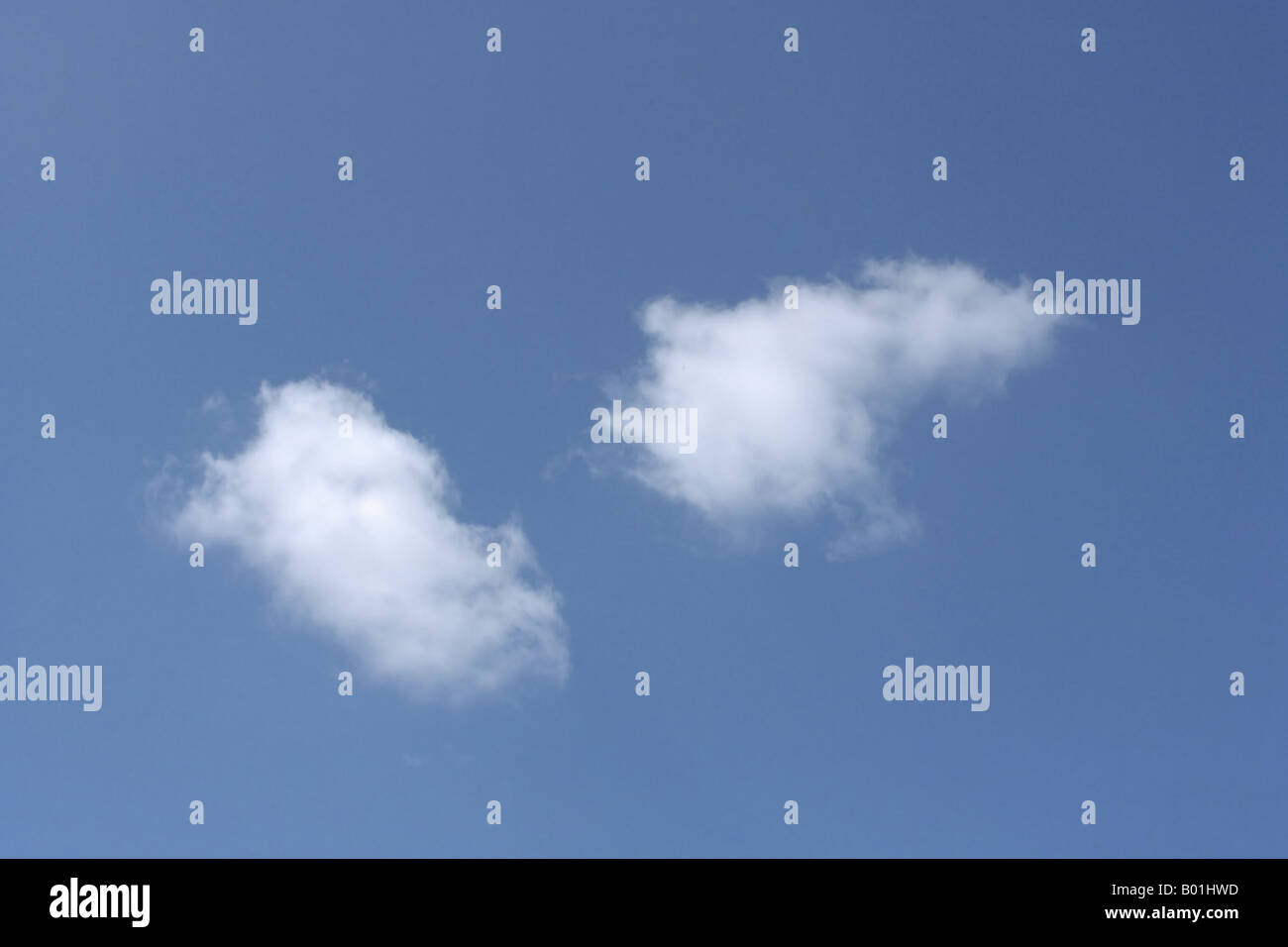 A picture of two white fluffy clouds in blue sky Stock Photo - Alamy