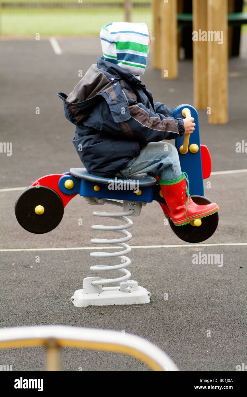 Childrens Playground with Soft Play Safety Surface Boy on Spring Rocker ...