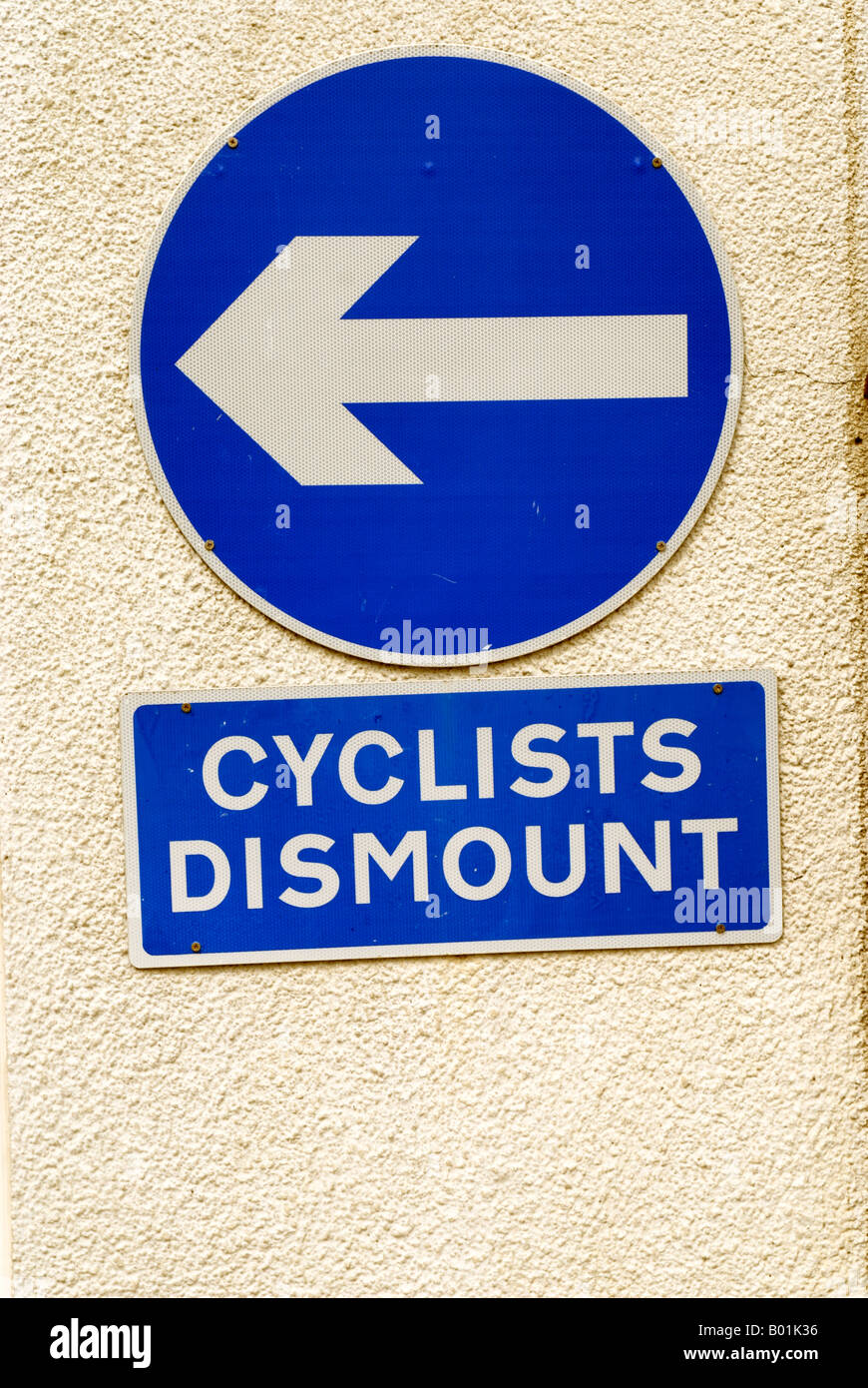 Oneway sign and cyclists dismount Stock Photo - Alamy