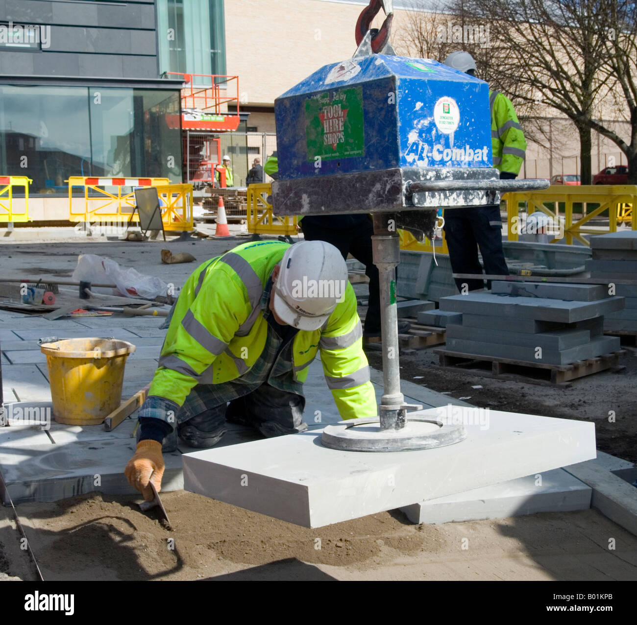 Men at work laying new pavements vacuum slab lifter in use hi-res stock ...