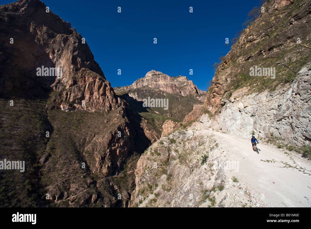 Preston McCoy mountain biking down a dirt road in the Copper Canyon ...