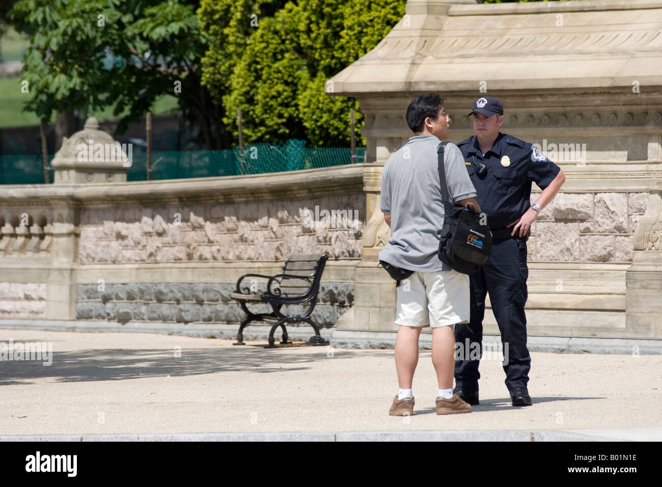 A Capitol Police officer speaks with a man near the Capitol Building in ...