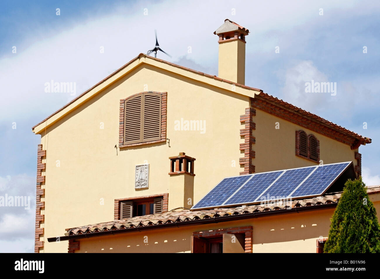Solar panels and wind generator on roof Stock Photo - Alamy