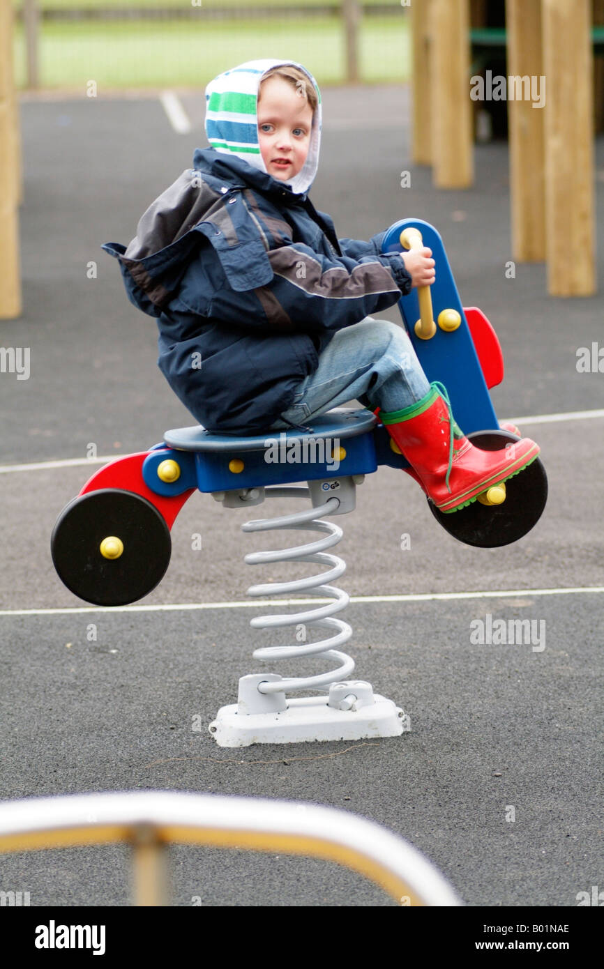 Childrens Playground with Soft Play Safety Surface Boy on Spring Rocker ...