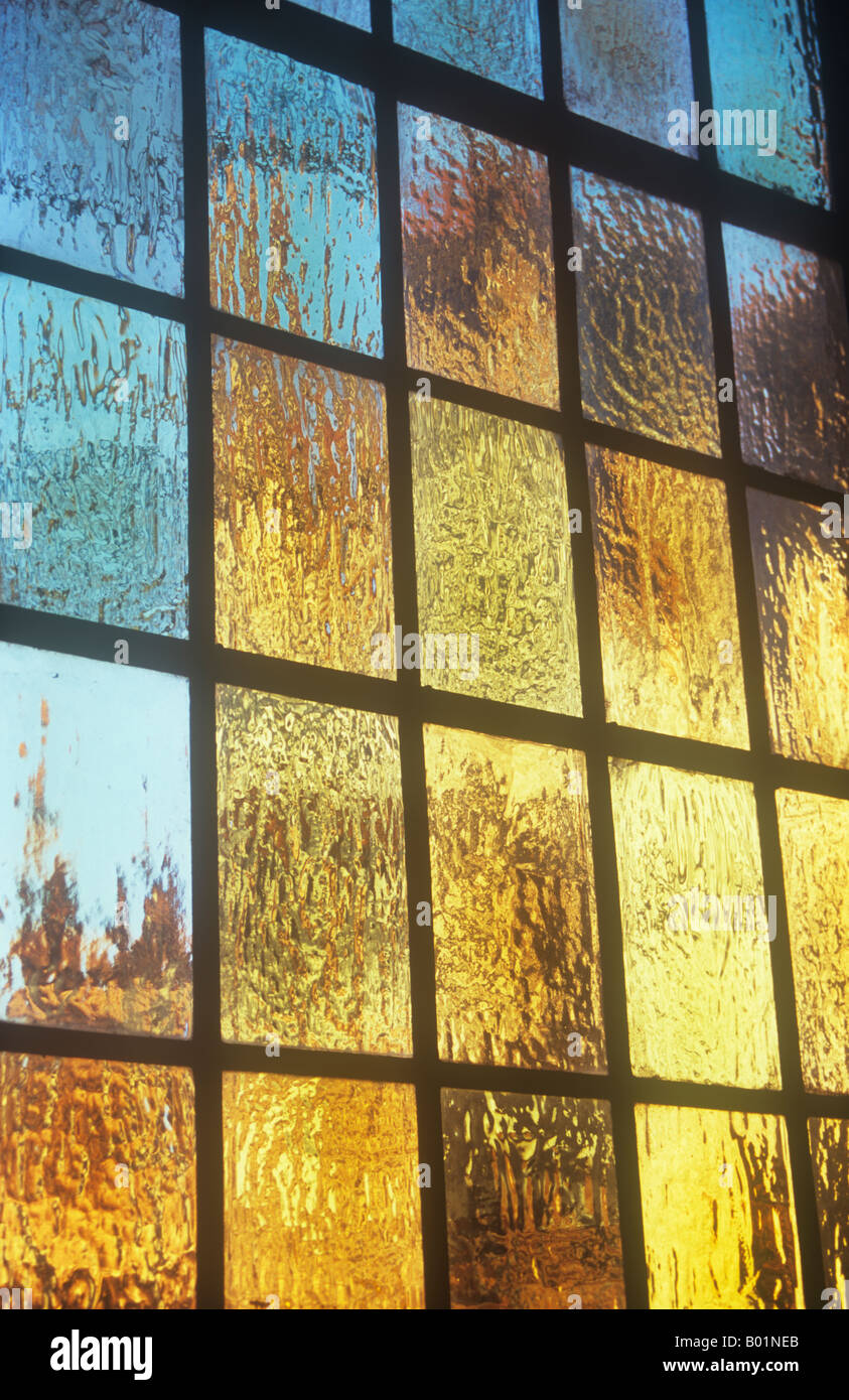 View through rectangular leaded textured window panes to yellow and ...