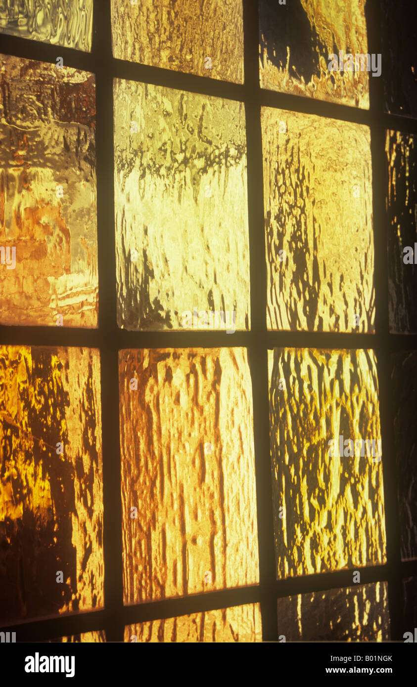 View through rectangular leaded textured window panes to an interior ...