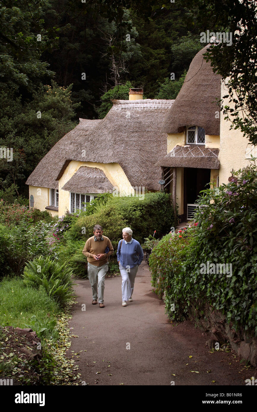 UK Exmoor Somerset Selworthy two visitors walking alongside the village ...
