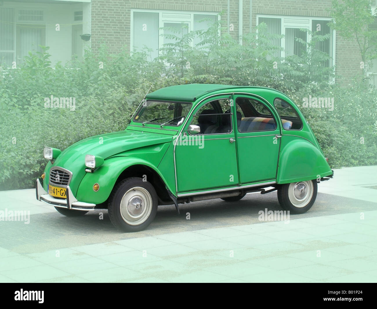 green citroen deux chevaux by roadside against green background Stock Photo - Alamy