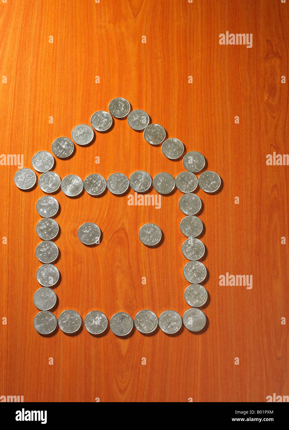 Shape of a house from coins Stock Photo - Alamy