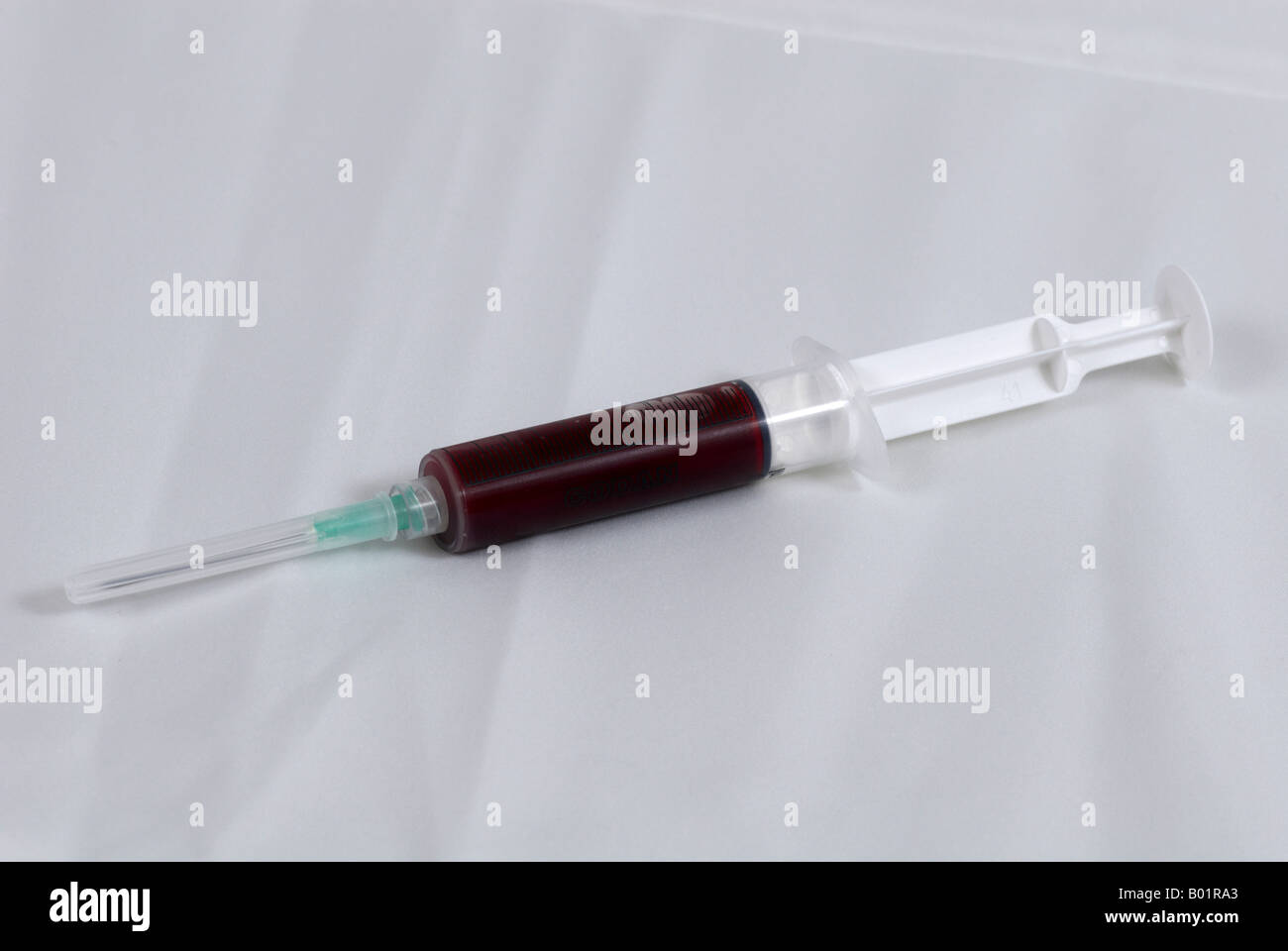 Blood in a syringe with needle attached Stock Photo - Alamy