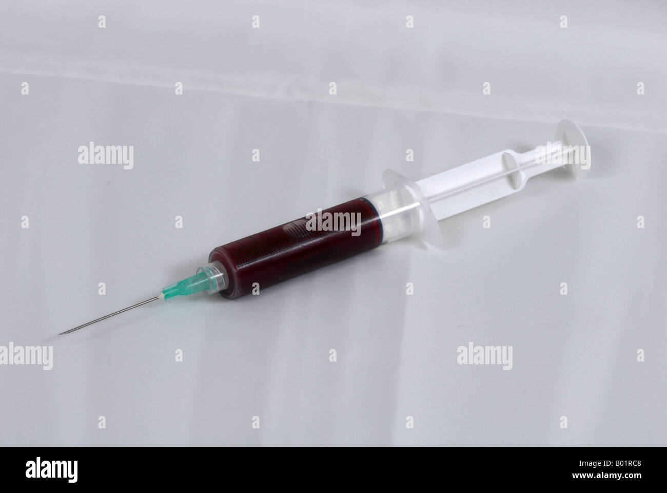 Blood in a syringe with needle attached Stock Photo - Alamy