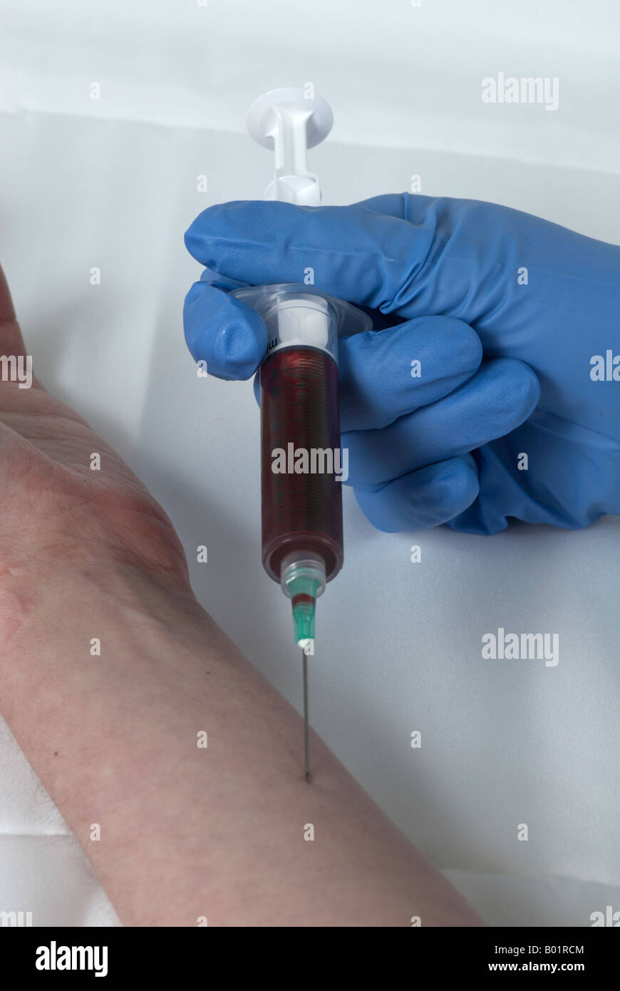 Simulating the use of a needle and blood and arm Stock Photo - Alamy