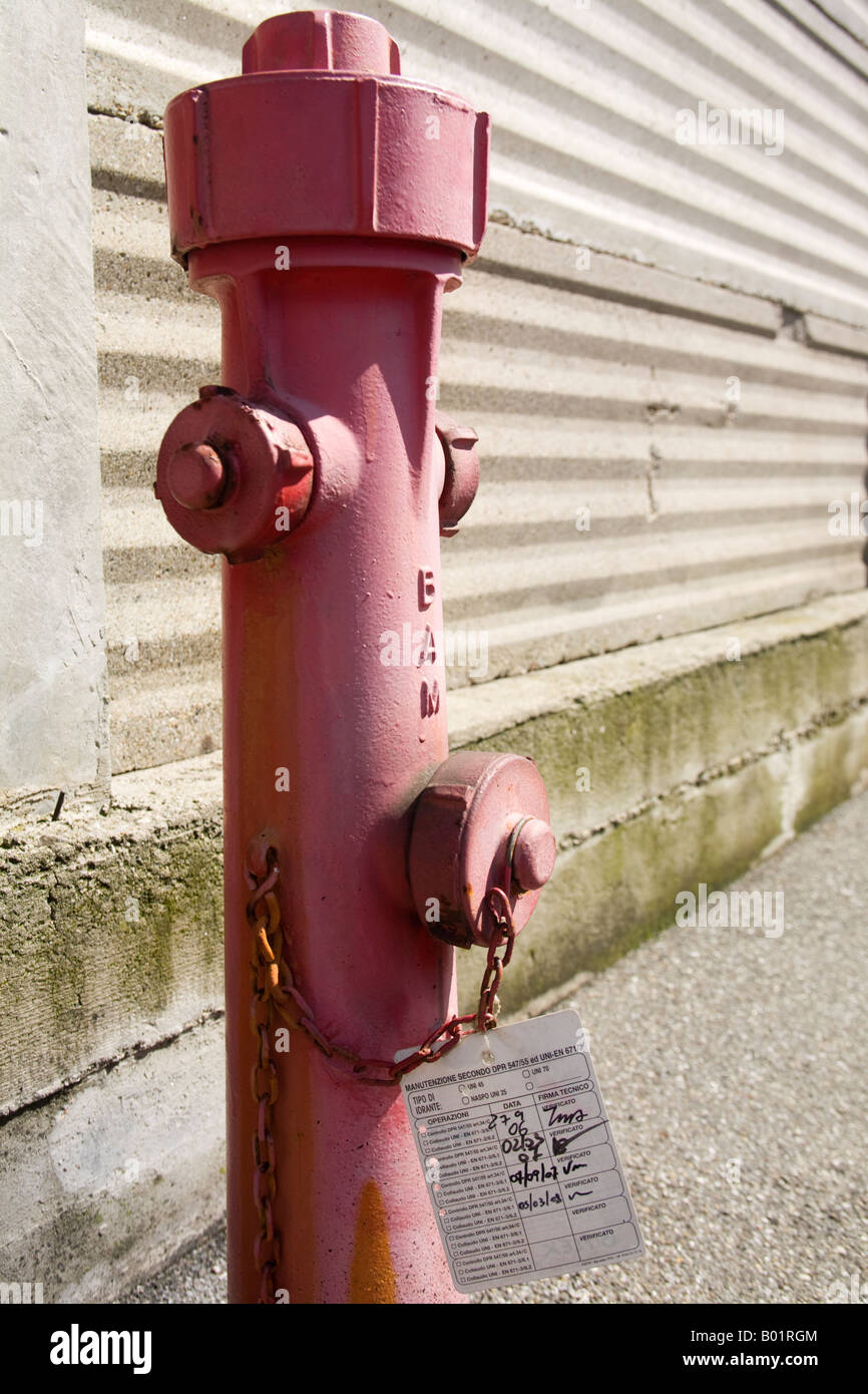 Red fire hydrant in industrial area with checking notice attached Stock ...