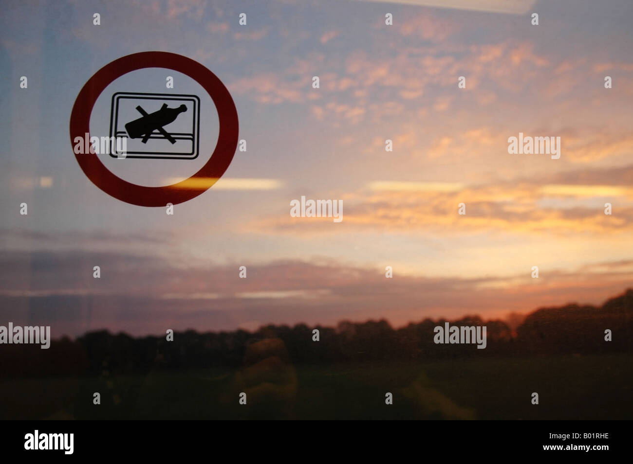sunset seen through train window with warning sign Stock Photo - Alamy