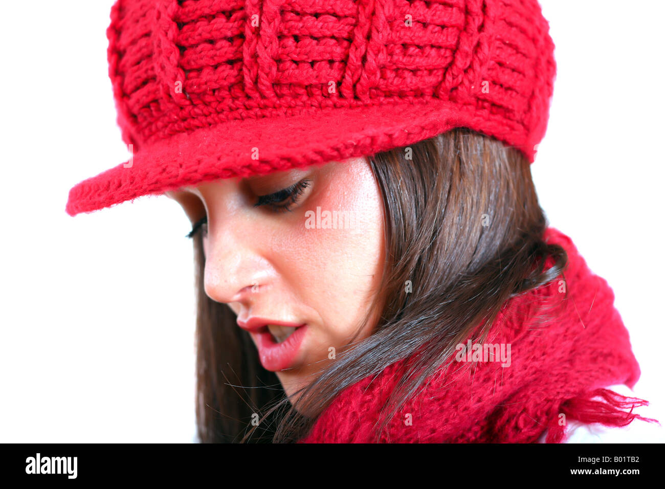 Sad brunette with a red hat and a red shawl Stock Photo - Alamy