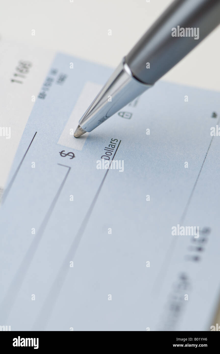 Writing a check Close up on the pen as it is writing Stock Photo - Alamy